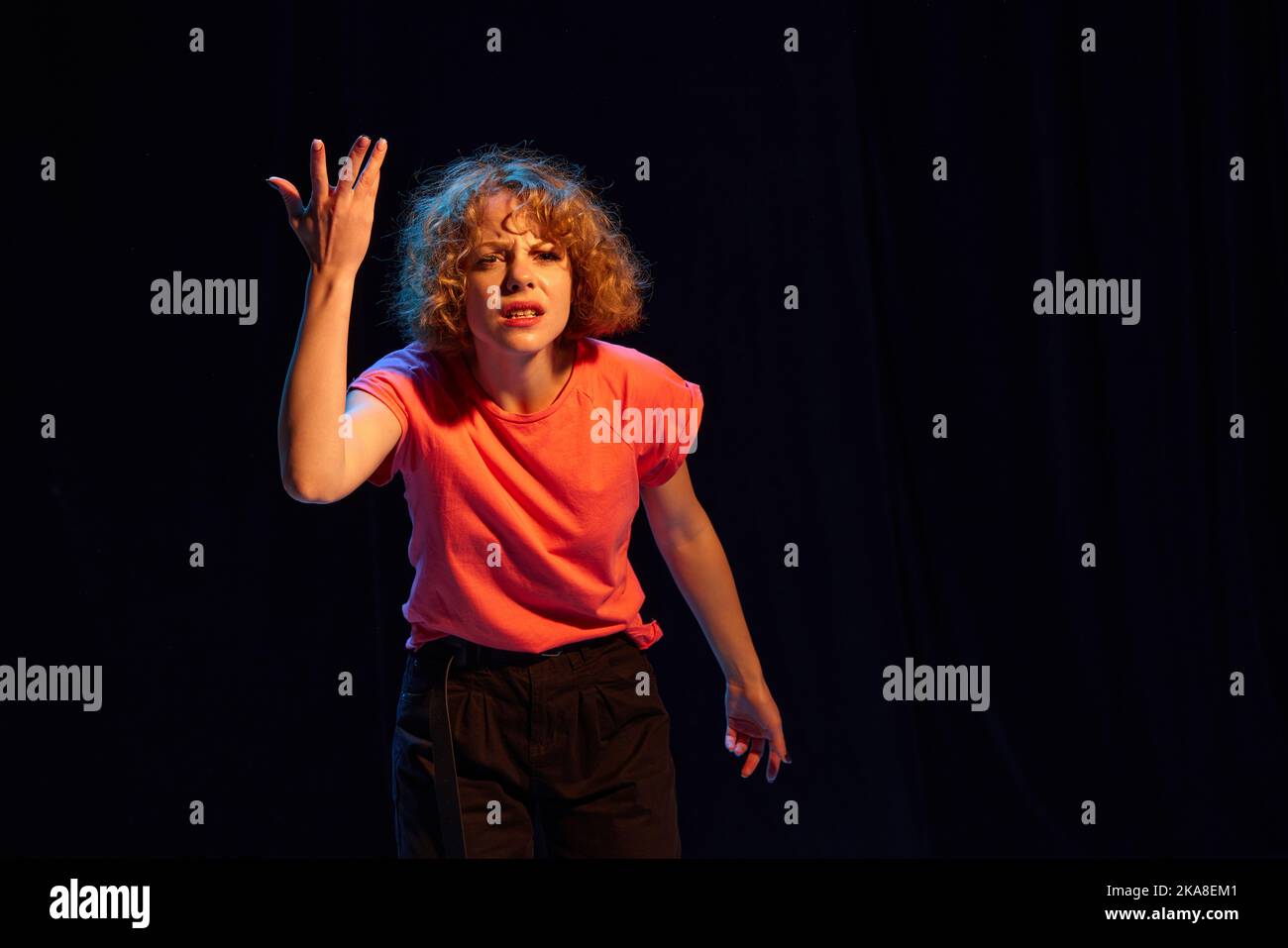 indignation. Young expressive emotional girl with short curly red hair ...