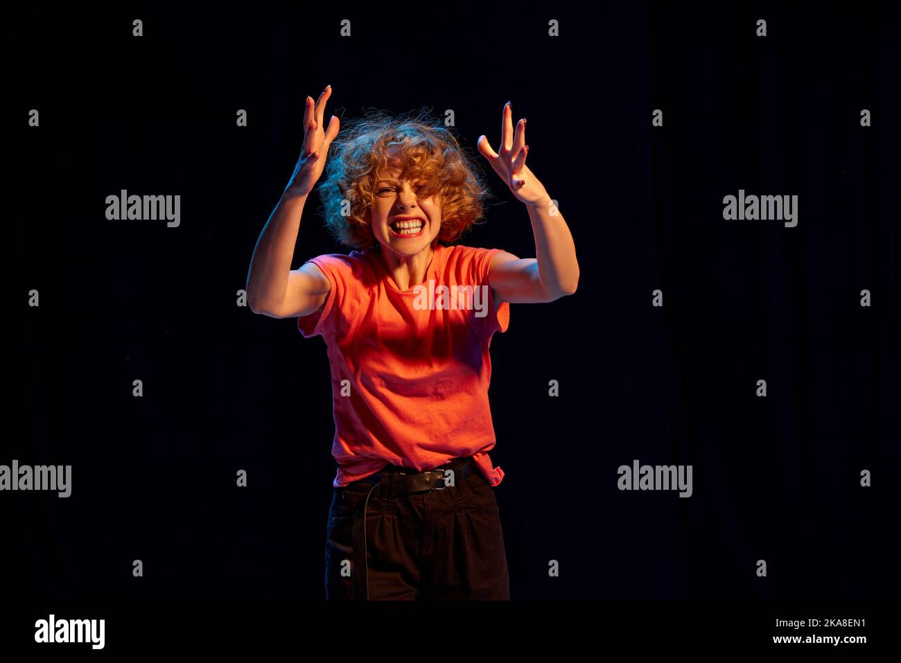 Anger. Young expressive emotional girl with short curly red hair posing ...