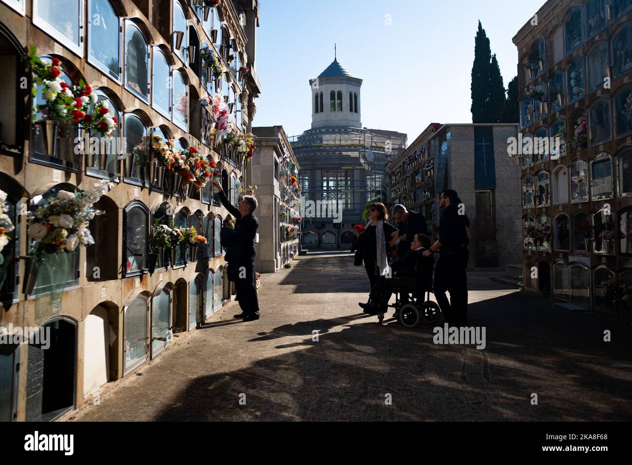Barcelona, Spain. 01st Nov, 2022. A family seen putting flowers on a ...