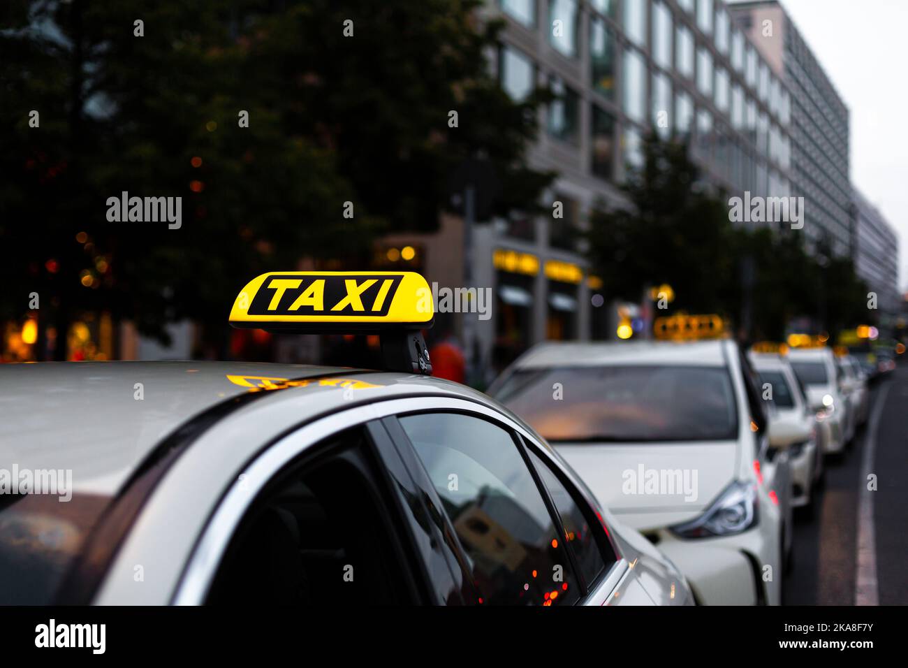 A row of parked cab cars along the sidewalk. Modern urban transport ...