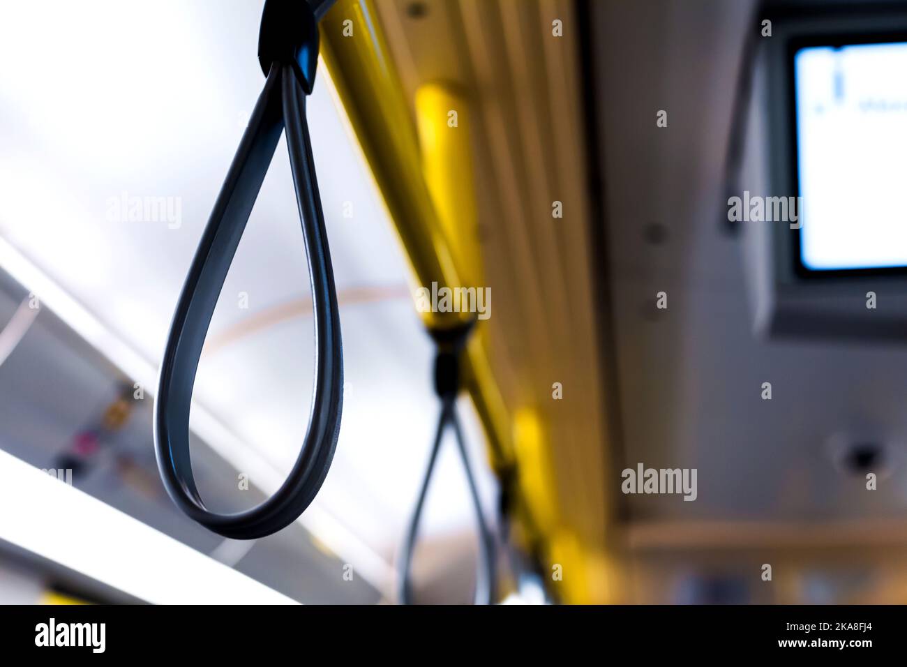 Handrail in the bus with hanging handgrips Stock Photo - Alamy