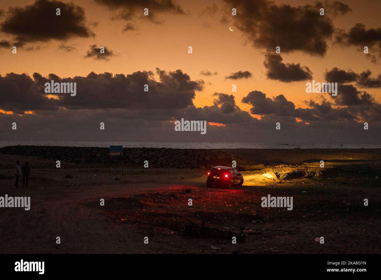 A closeup of a car running on the path going to the beach at sunset ...