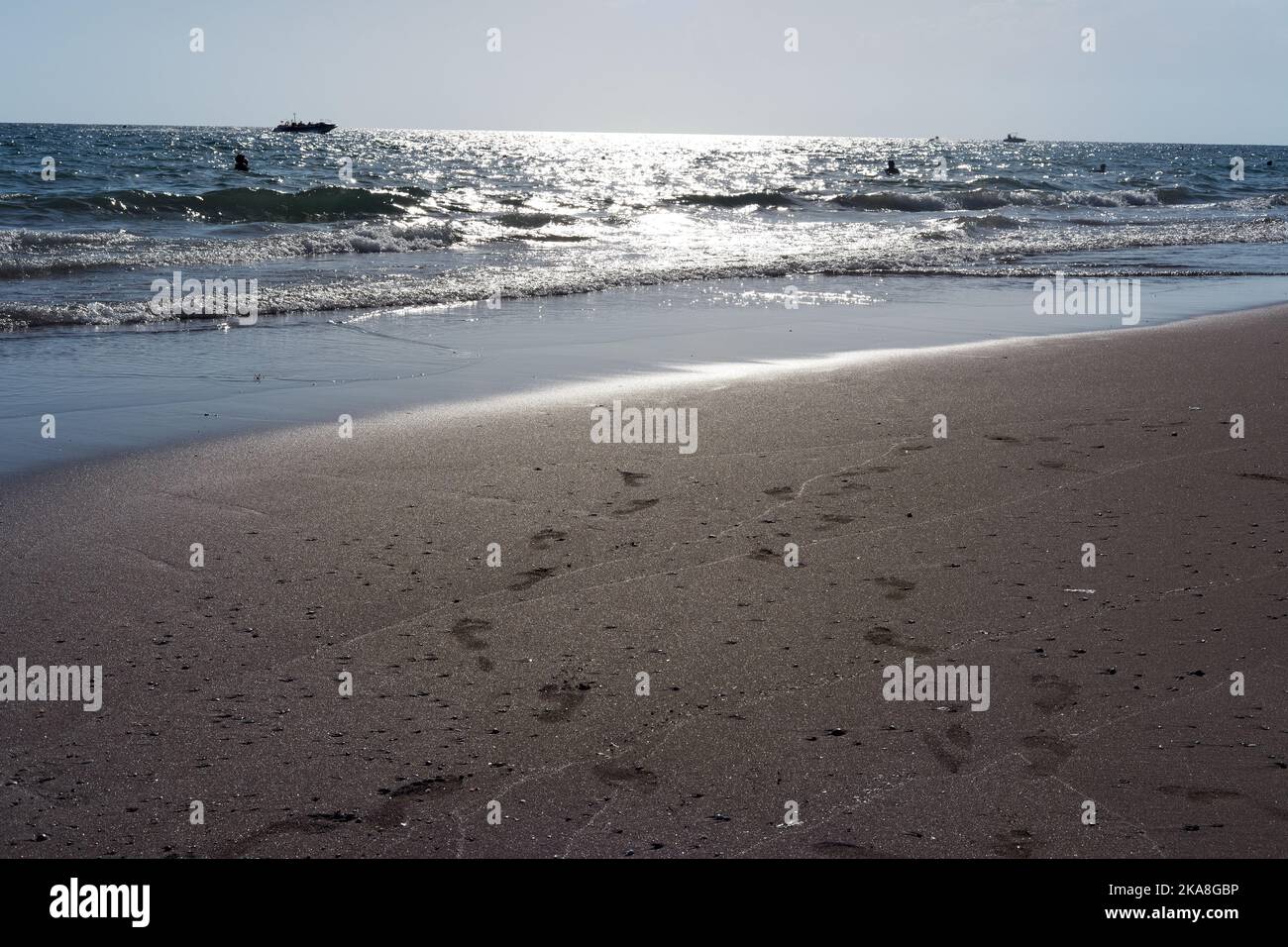 Sandy beach and reflections of sunlight on the sea surface Stock Photo ...