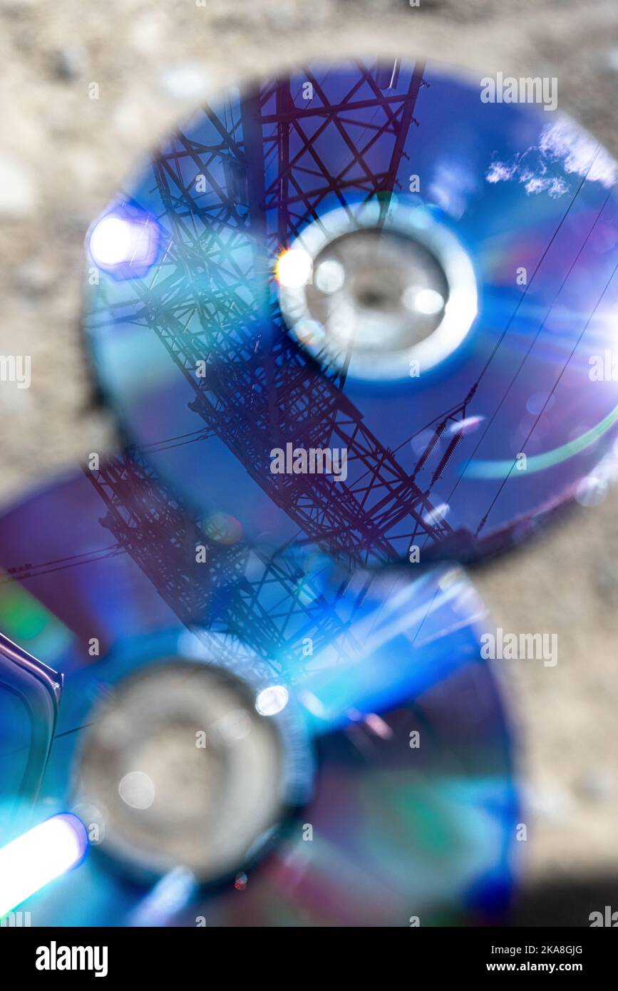 A view of CDs laying on the ground with reflection of power pole Stock ...