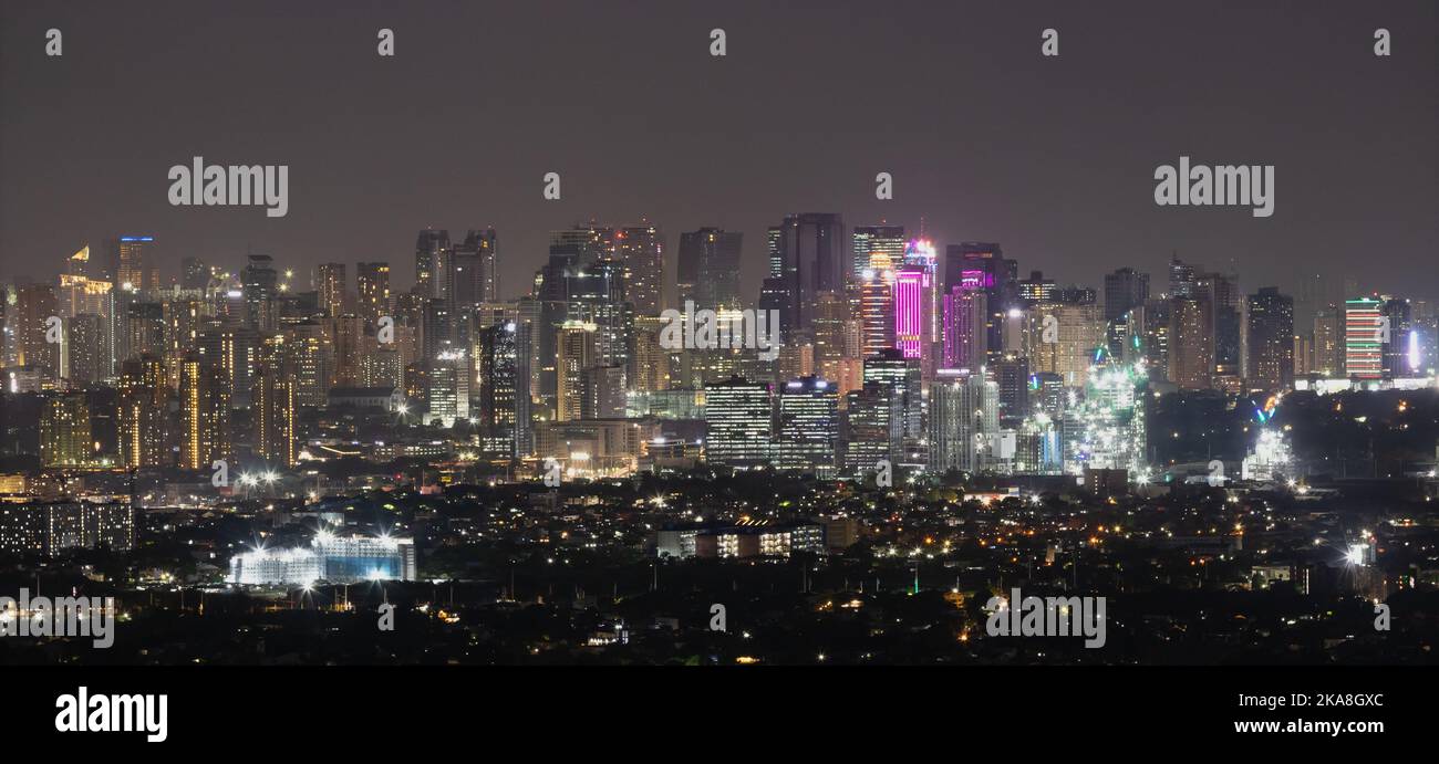 A night view of the illuminated buildings of Manila Stock Photo - Alamy