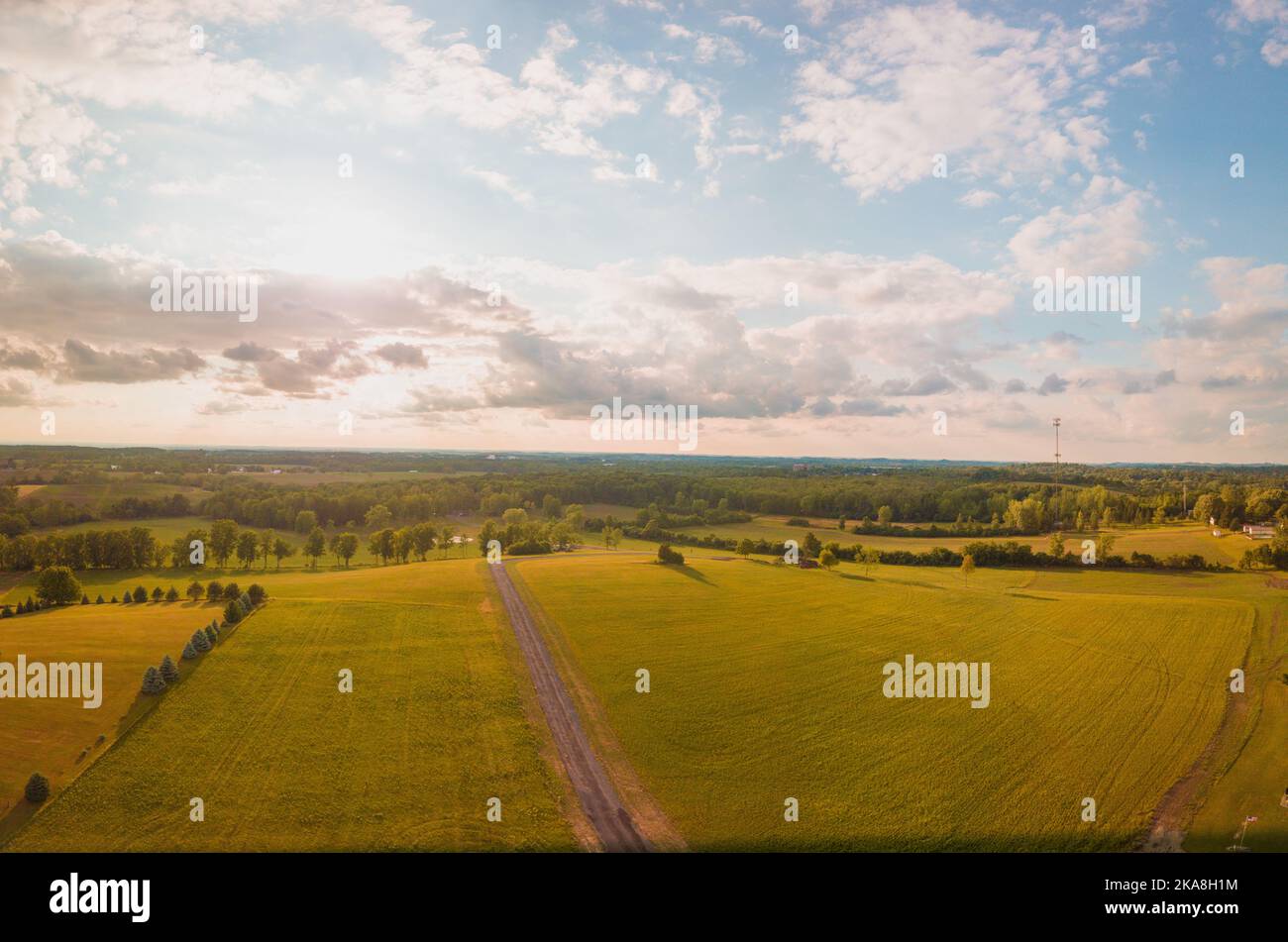 A bird's eye view of green fields at sunset near Owasco Lake in Auburn ...