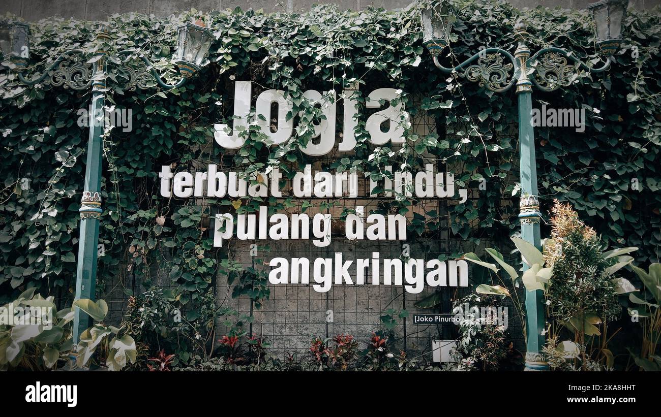 A view of fragment of a poem from Joko Pinurbo surrounded by green ...