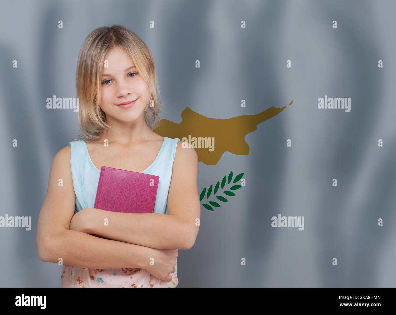 School girl with book against flag of Republic of Cyprus background Stock Photo - Alamy