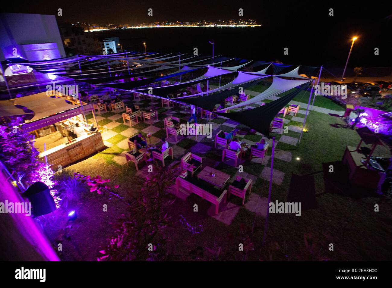 Terrace restaurant with purple neon lights Stock Photo - Alamy