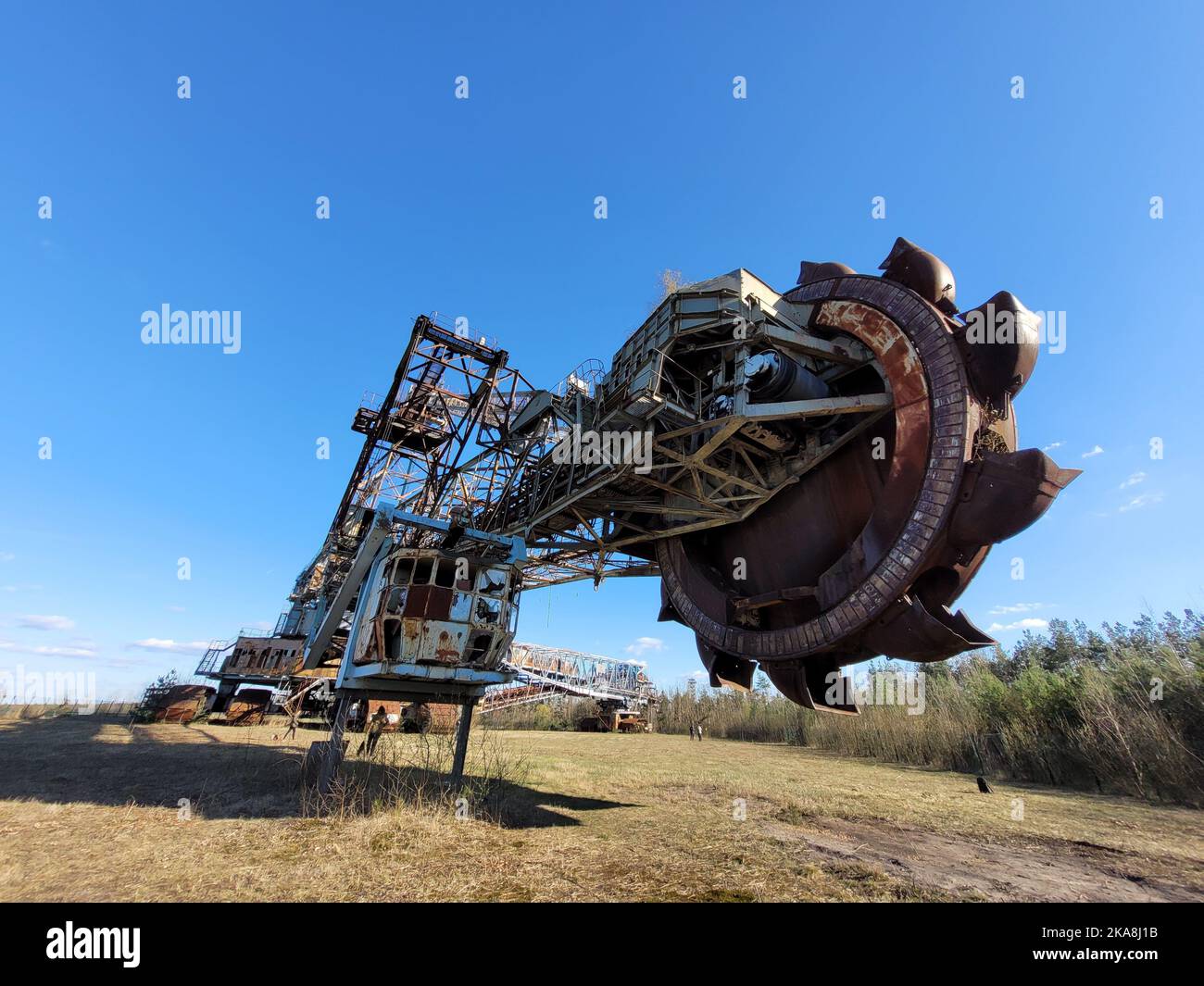 A bucket-wheel excavator Bagger in a reen field under the clear sky ...