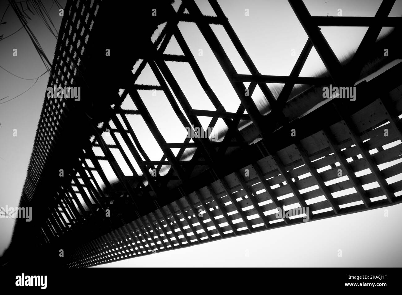 A grayscale of a metal boardwalk Stock Photo - Alamy
