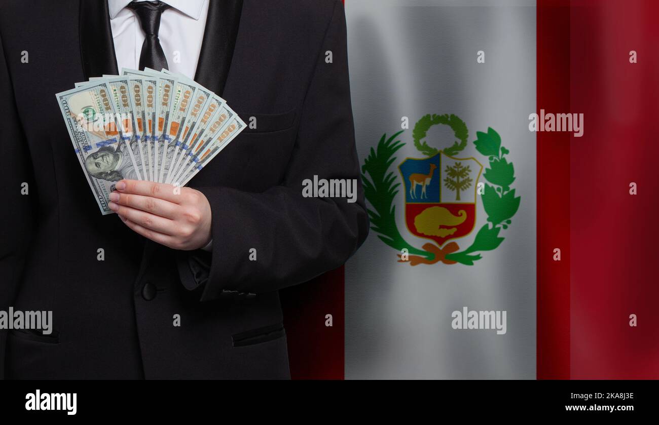 US dollar bills money banknotes in hand against flag of Peru background ...