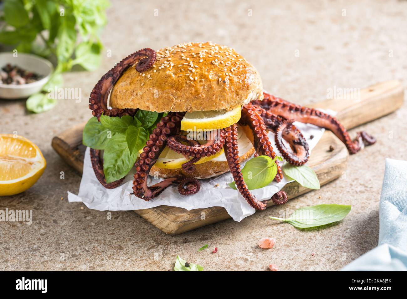 Big burger with octopus and lemon. Large sandwich stuffed with seafood ...