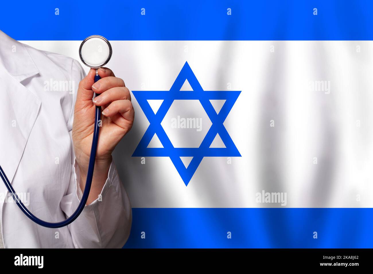 Israeli medical worker's hand with stethoscope on flag of Israel ...