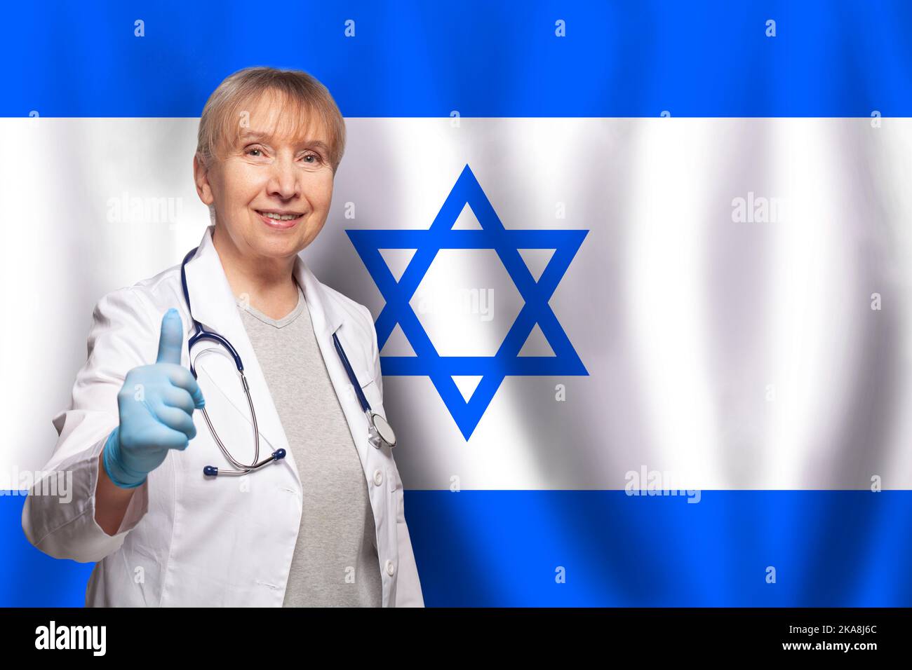 Israeli smiling mature doctor woman holding stethoscope on flag of ...