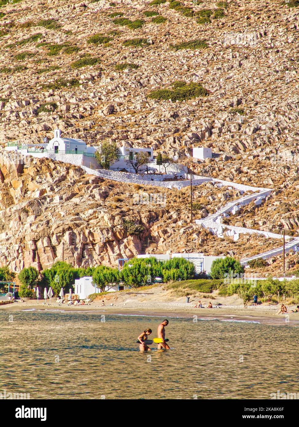 A vertical view of a beach with mountains in Kameras village, Sifnos ...