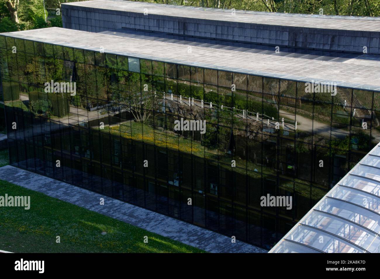 A view of a modern building with reflective windows Stock Photo - Alamy