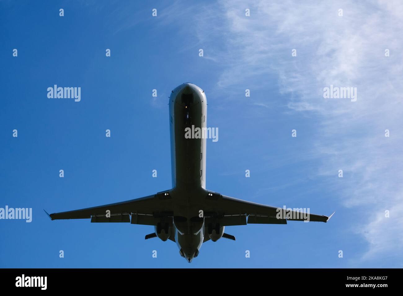 airplane on approach for landing, close-up, blue sky Stock Photo - Alamy