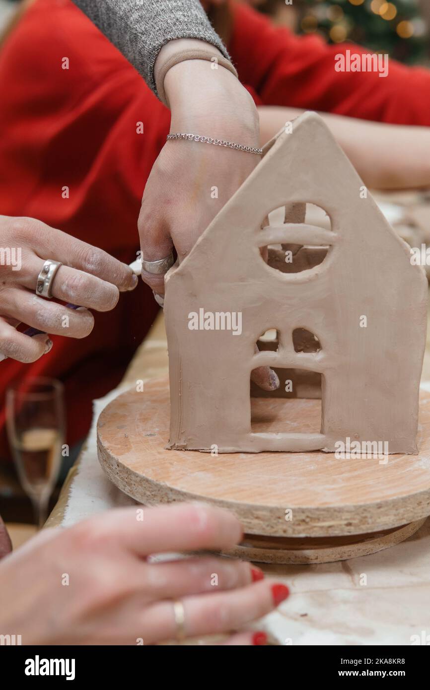 Women's hands knead clay, drawing elements of the product. Production ...