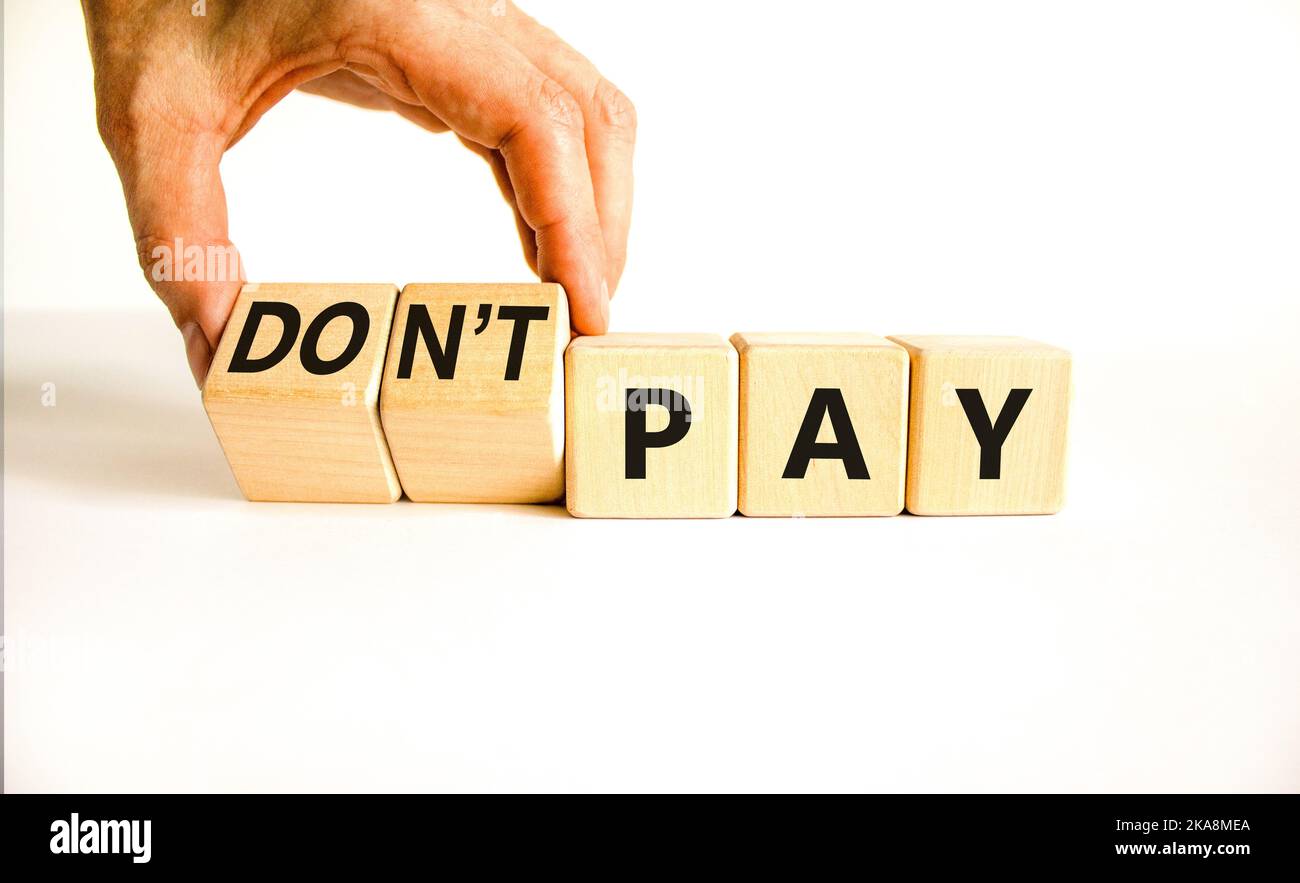 Do not pay symbol. Concept words do not pay on cubes. Businessman hand ...