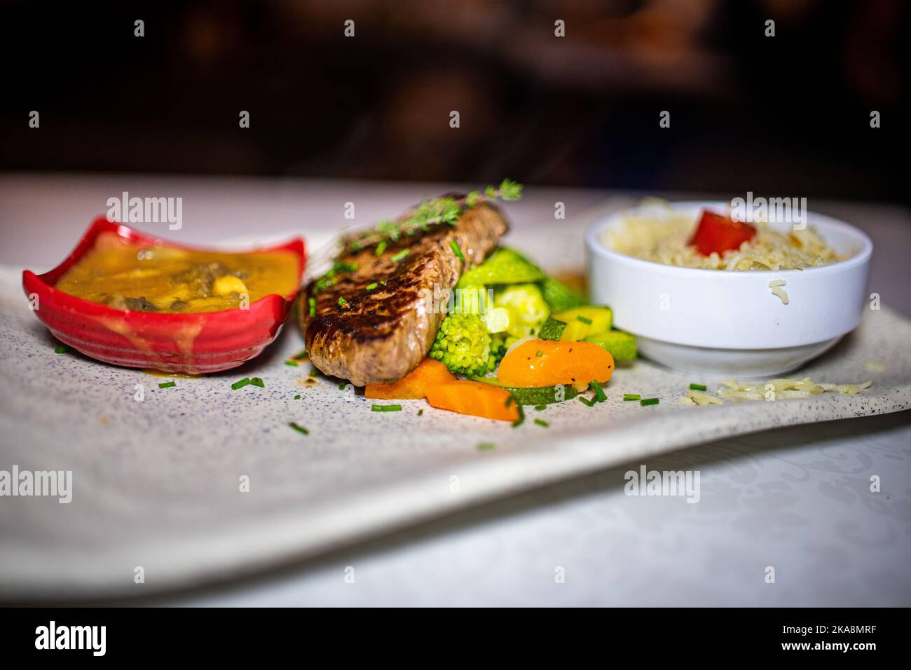 Beef stake with Broccoli and carrot on a glossy plate Stock Photo - Alamy