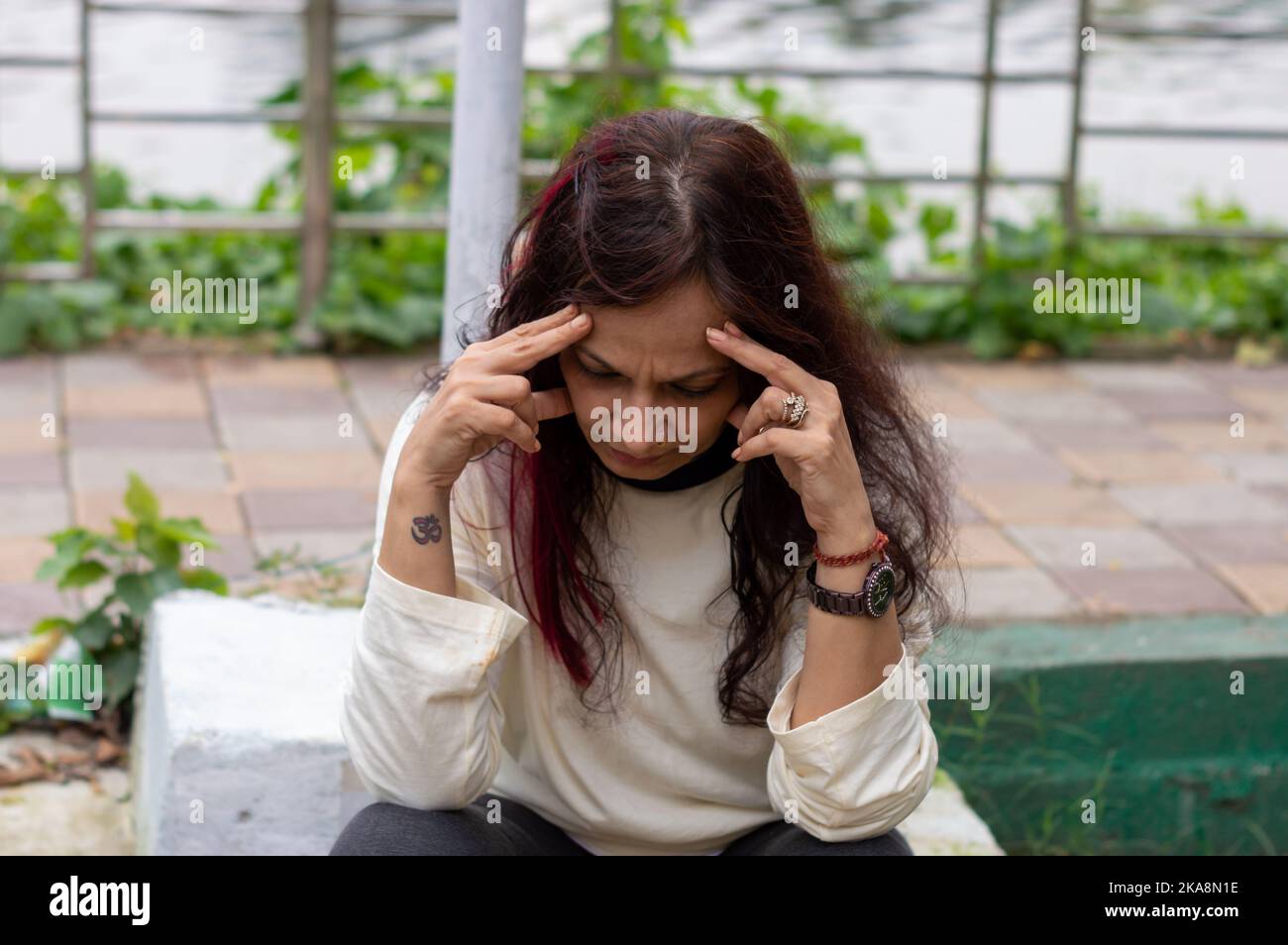 Depressed worried Woman sitting in stress pose in a park bench and ...