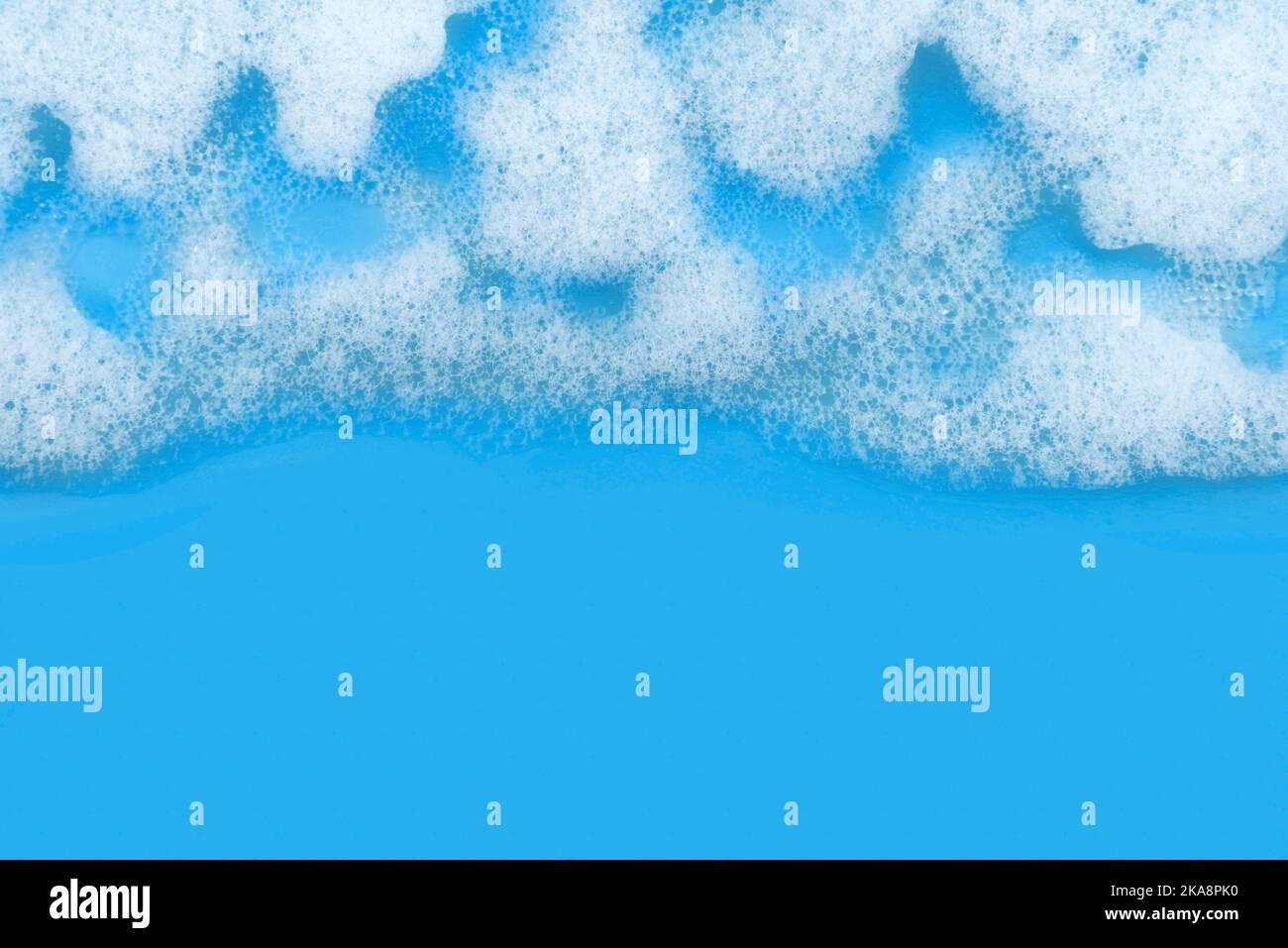 Soap foam. Background of dusty foam with bubbles of blue color for an ...
