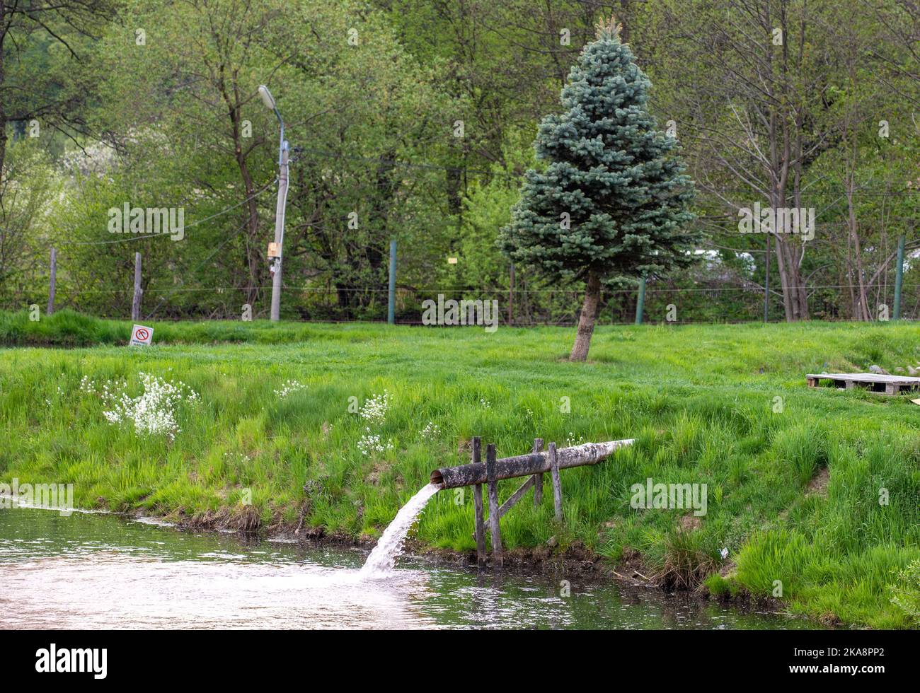 a pipe through which polluted water flows in nature, dirt, toxic Stock ...