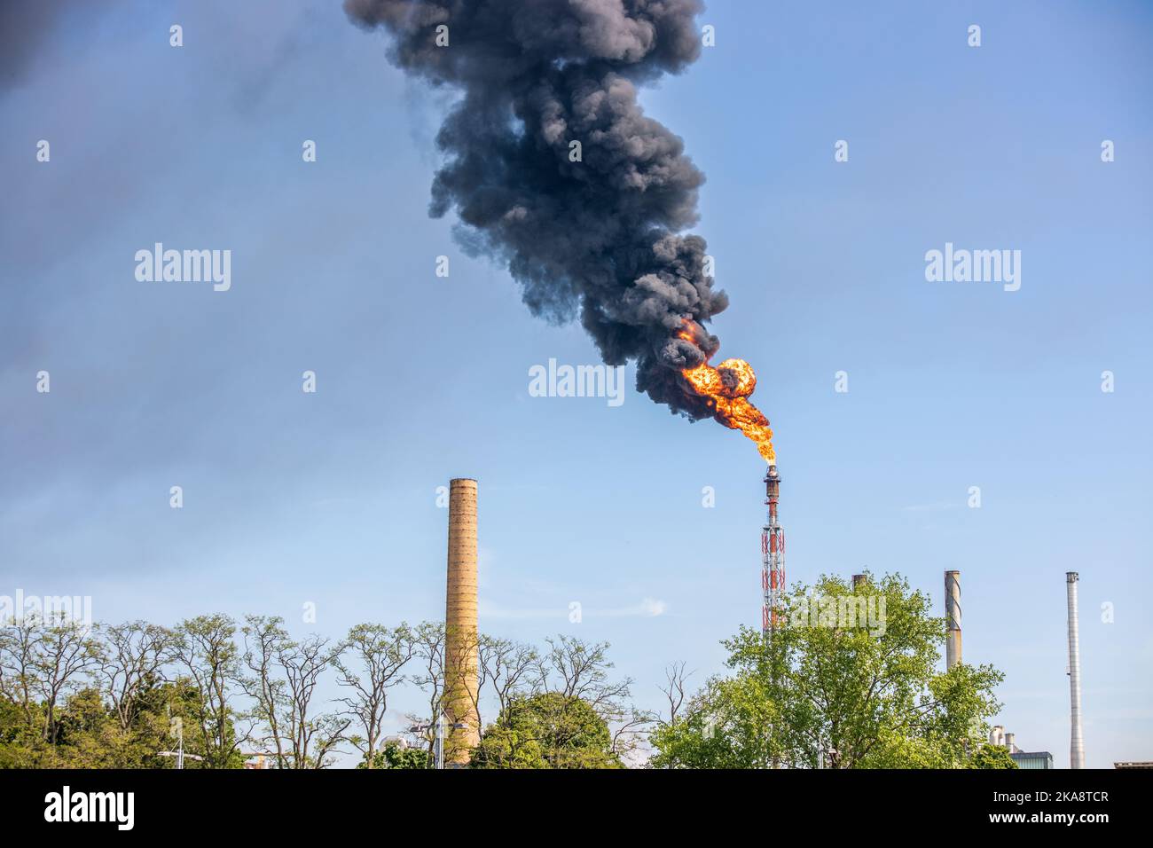 A power tower burning in the daytime Stock Photo - Alamy