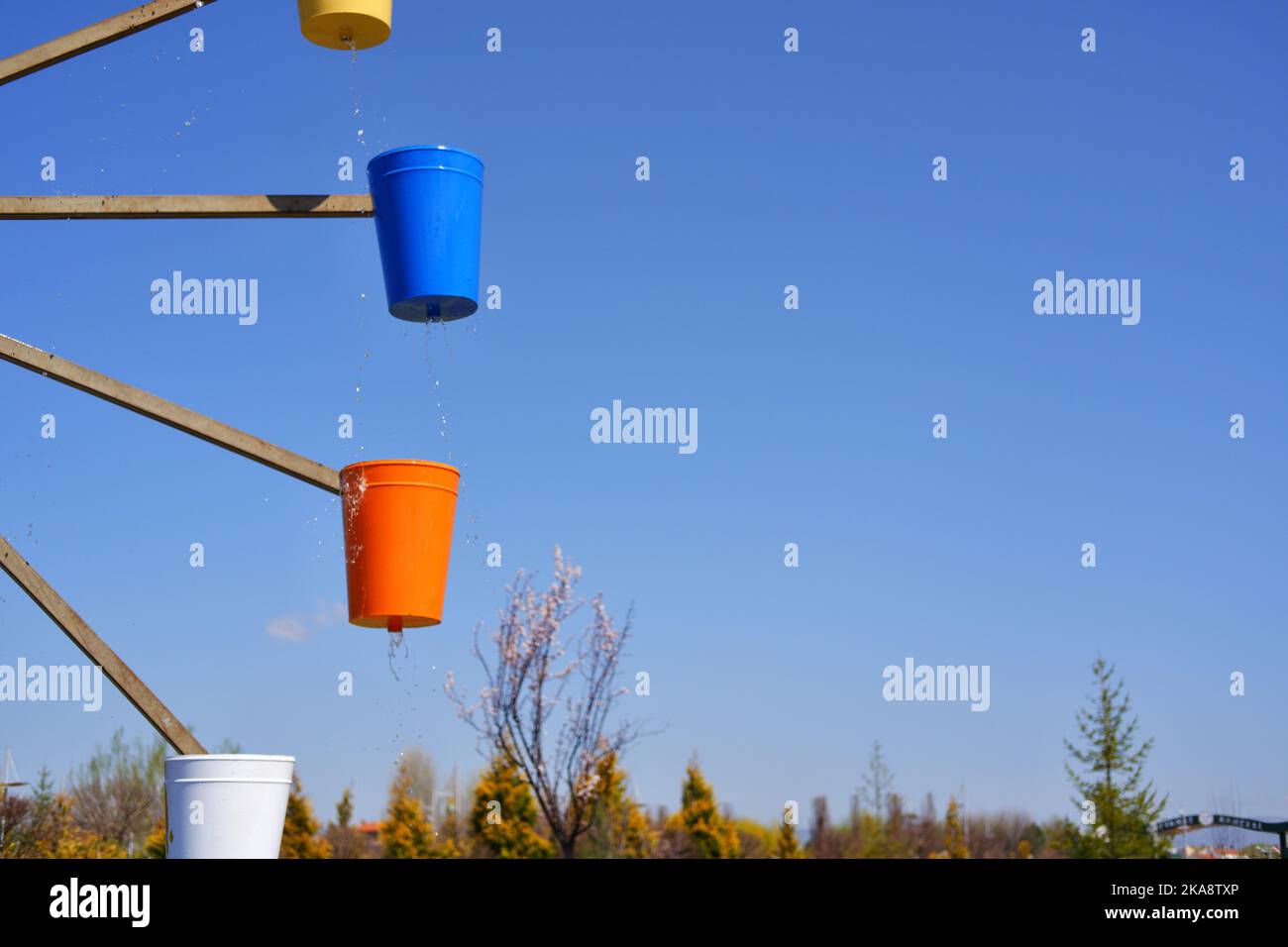 Watermill with colorful buckets sunny day at park Stock Photo - Alamy