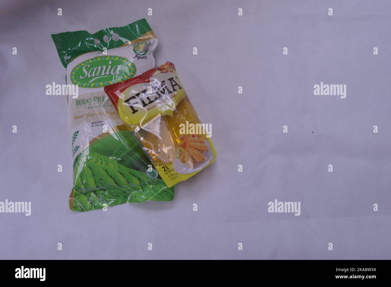 Packaged rice and cooking oil on a white background Stock Photo - Alamy