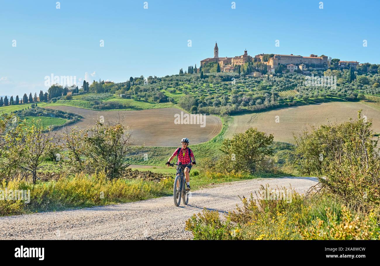 nice senior woman riding her electric mountain bike in the Ghianti area ...
