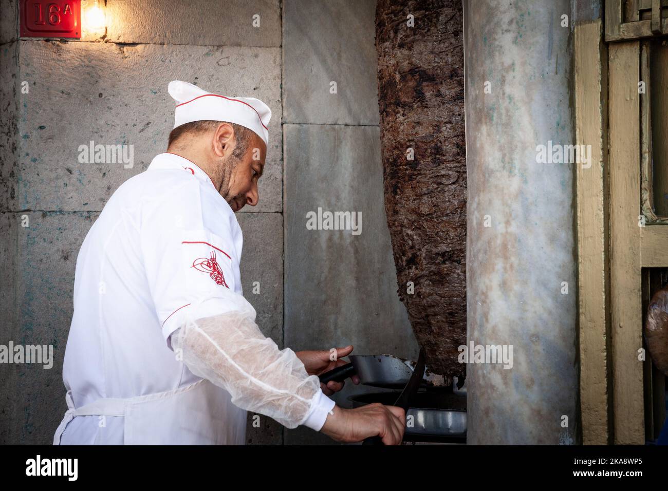 Picture of a man, a chef, a kebab master, preparing to cut some meat of ...
