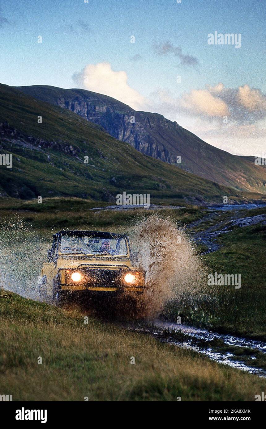 Land Rover Defender 90 V8 driving off road in Scotland UK Stock Photo ...