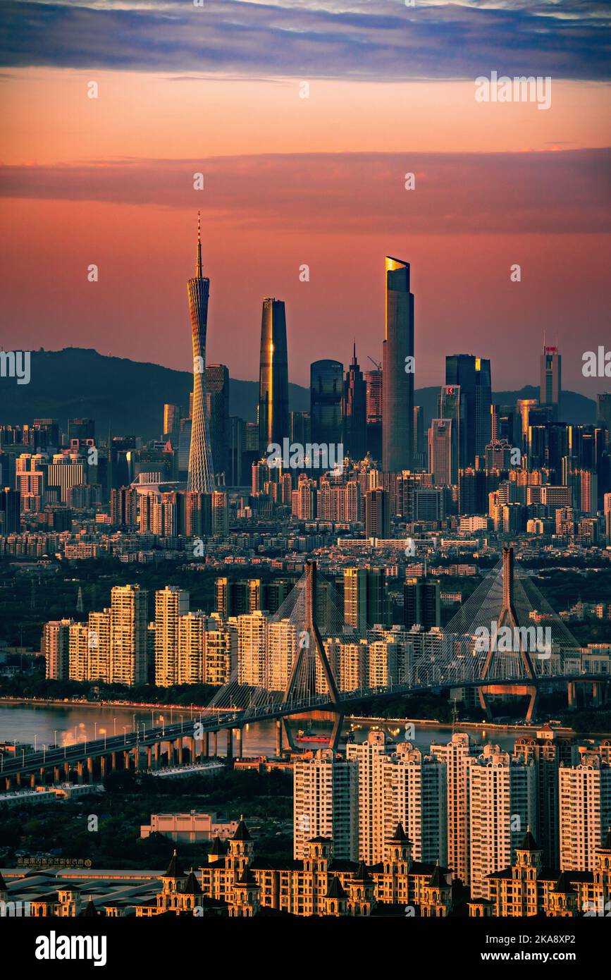 A vertical shot of Guangzhou cityscape with Canton Tower at sunset ...