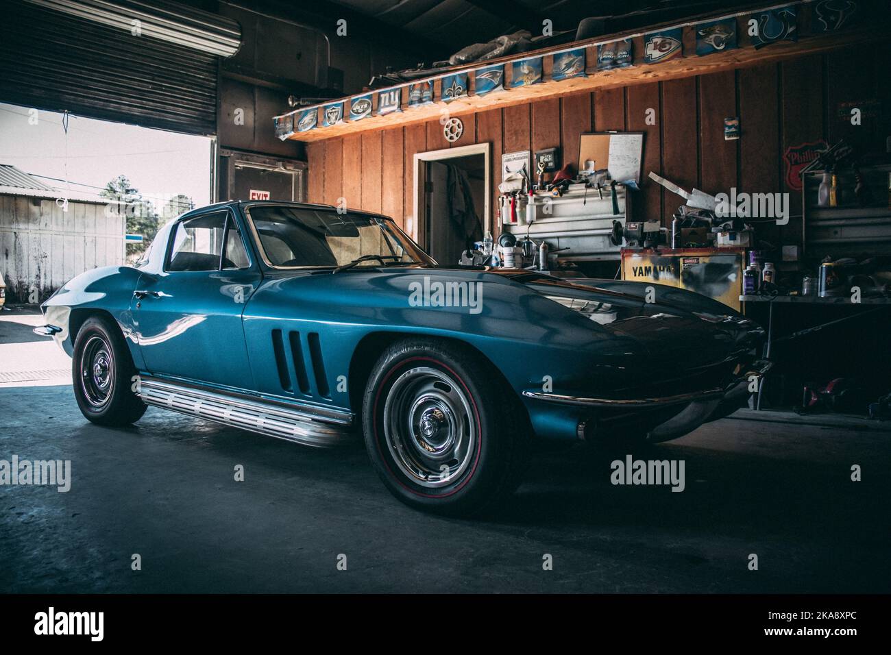 A view of old school blue Corvette Classic car in garage Stock Photo ...