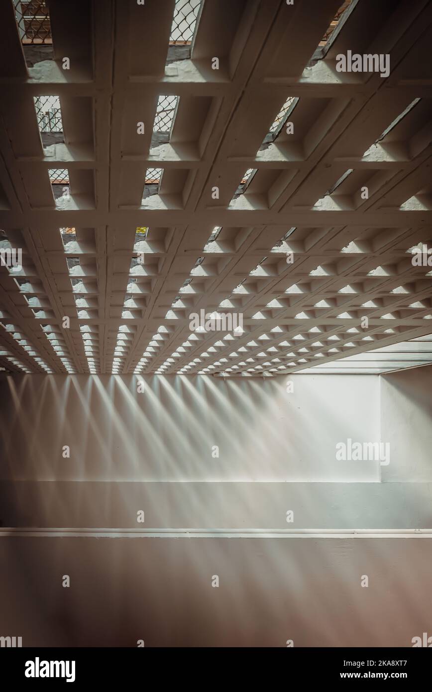 The sunlight shines through light channels wall of old gymnasium ...