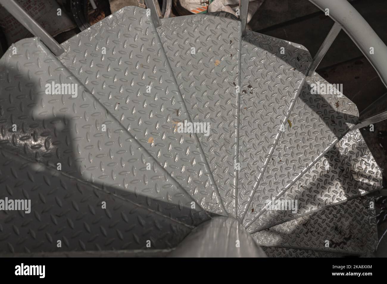 Top view of metal steps of outside spiral staircase with sunlight and ...