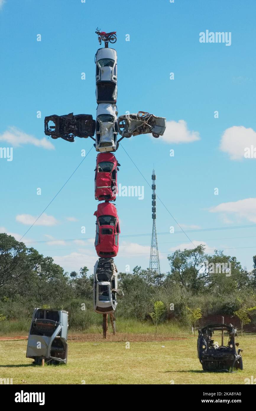 A vertical shot of a cross of cars topped with a motorcycle to impact ...