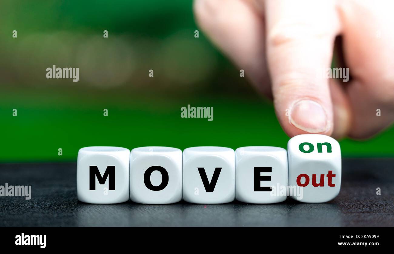 Hand turns dice and changes the expression 'move out' to 'move on ...