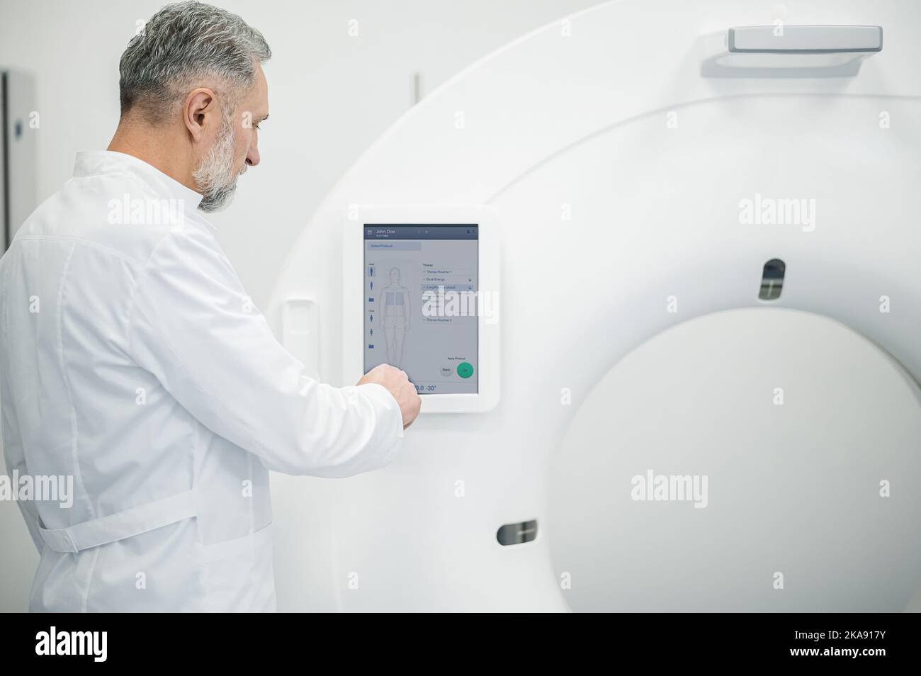 Mature radiologist standing near hi-res stock photography and images ...