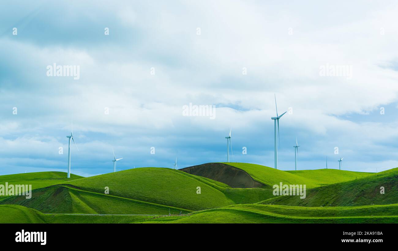A beautiful view of wind turbines in the field against a cloudy sky ...