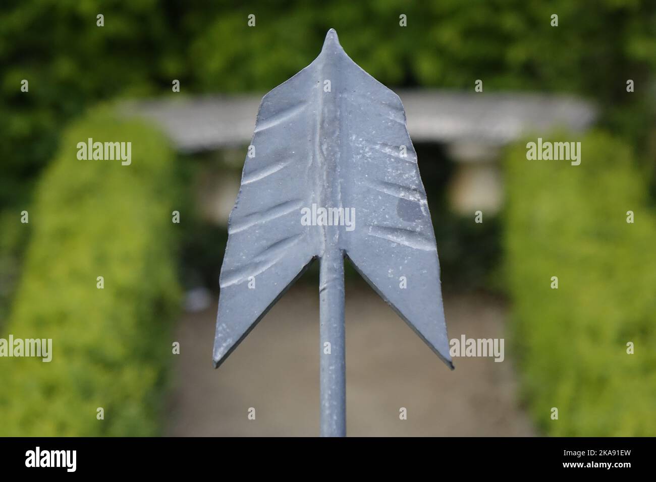 Metal arrow tip pointing forward in spring, concept: target, focus ...