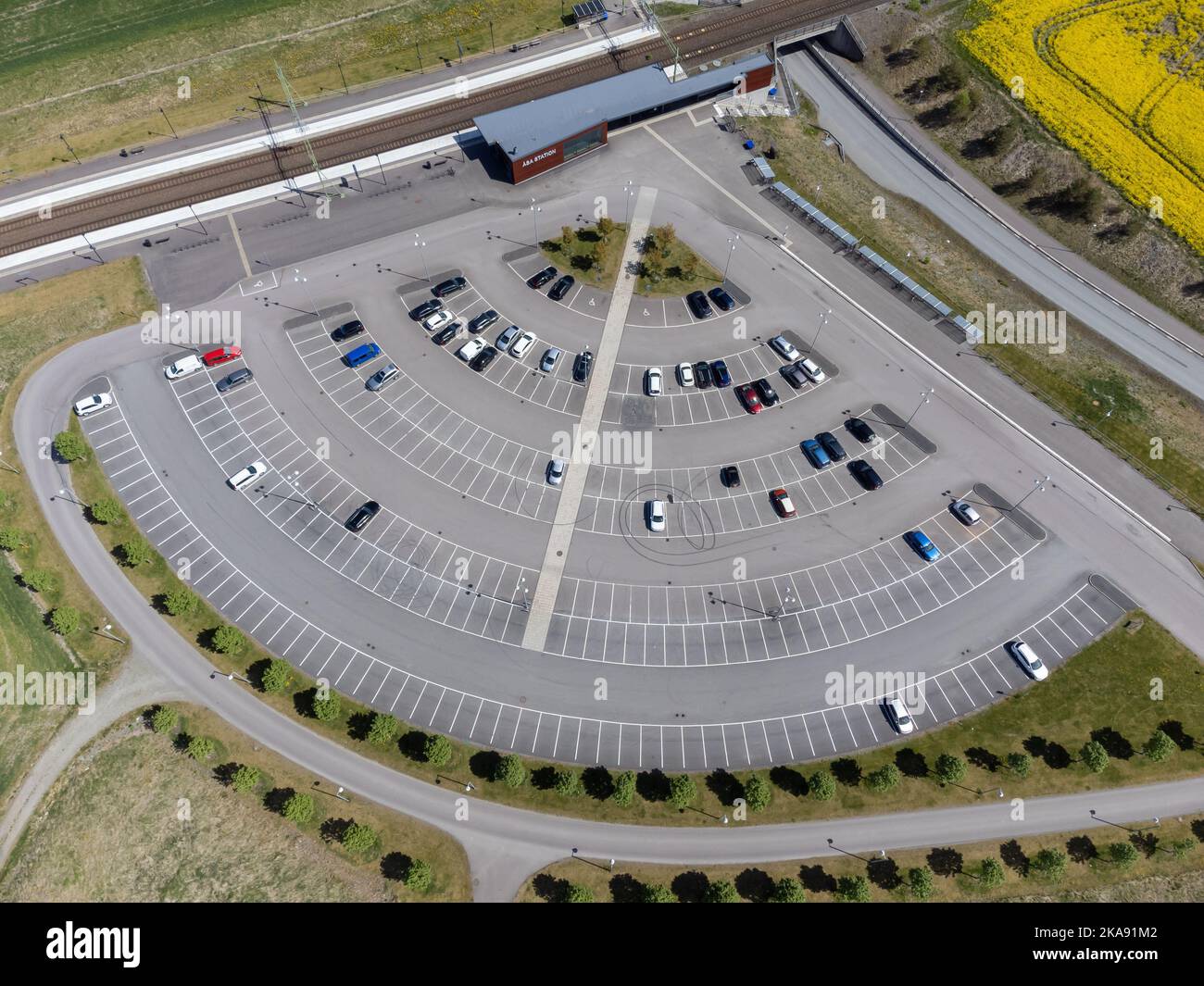 Aerial view of train, railway station, with parking spots, spaces, car ...