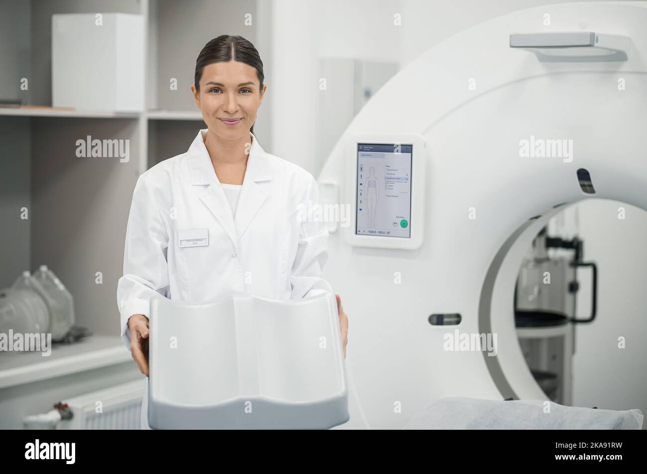 Long-haired doctor preparing MRI scanner for work Stock Photo - Alamy