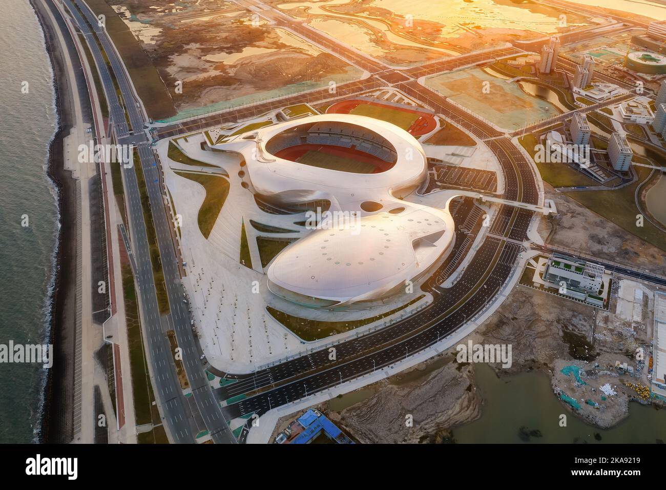 The aerial shot of a football stadium in Guangzhou at sunset. China ...