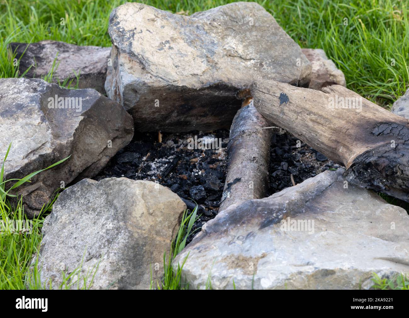 The remains of an old fire pit with some burned wood left inside Stock ...