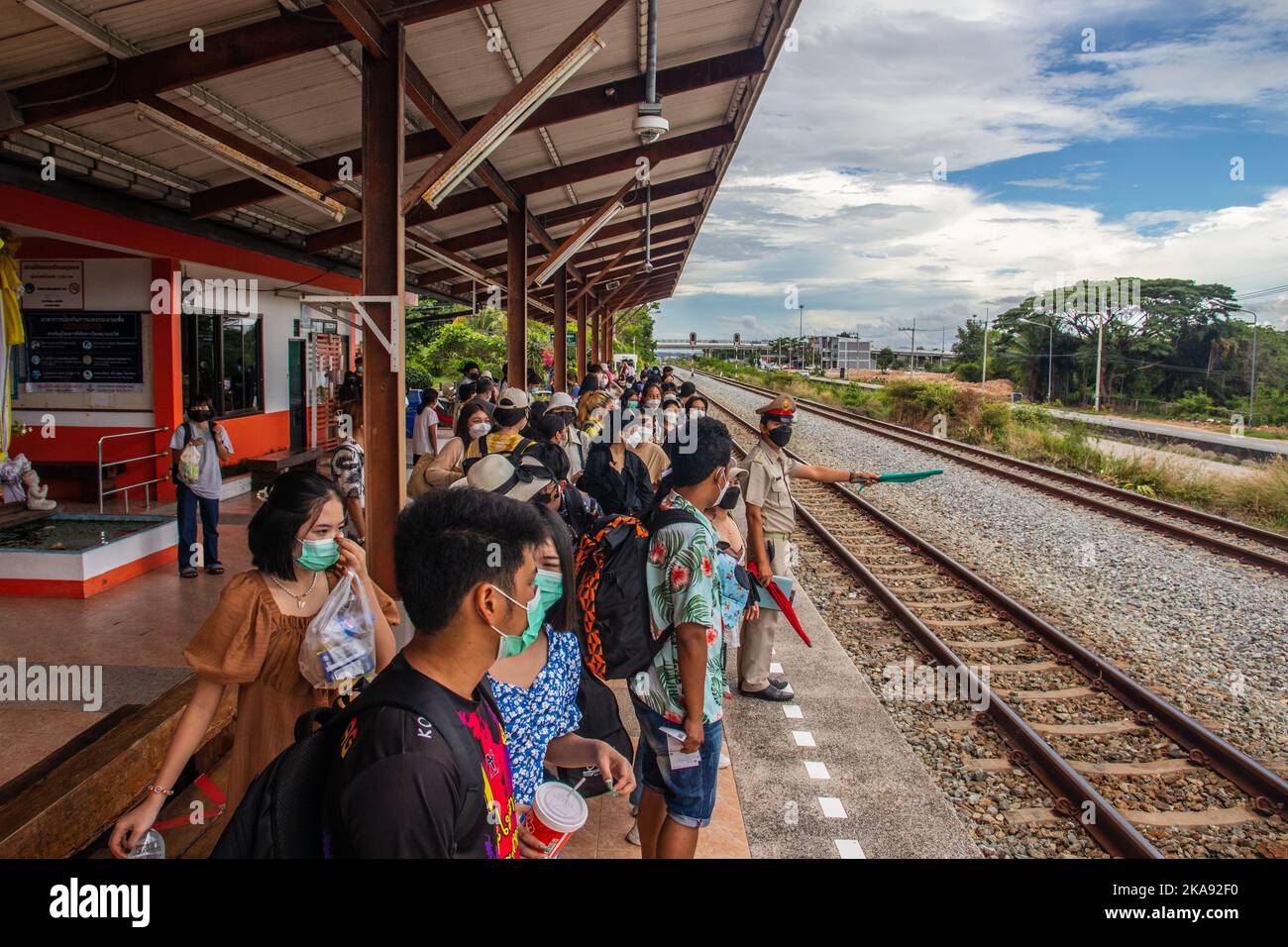 People wait at a platform in Pattaya for the incoming train bound for ...
