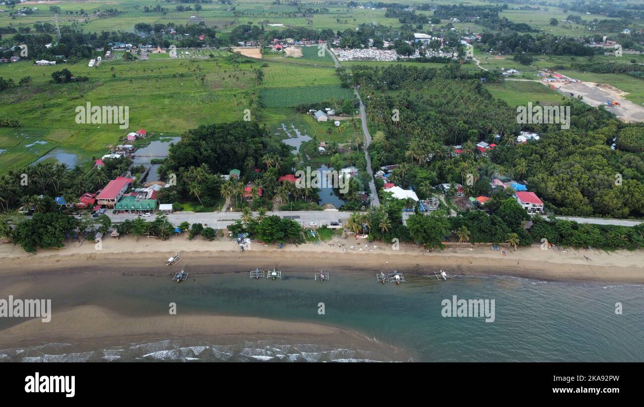An aerial drone shot overlooking Bayawan Boulevard and the ocean, the ...