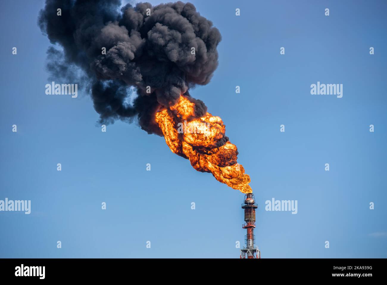 A power tower burning in the daytime Stock Photo - Alamy